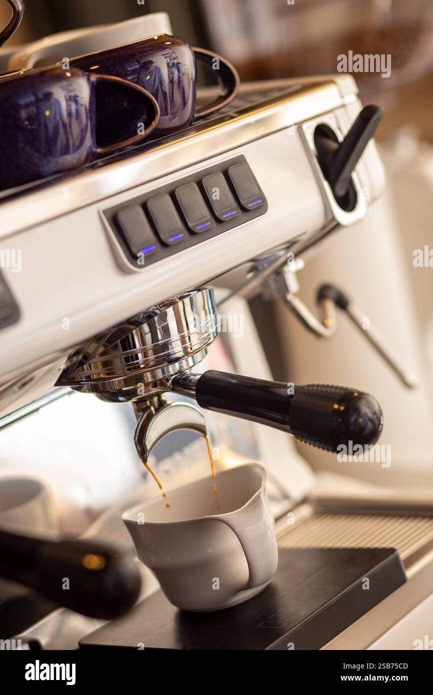 Closeup of pump driven espresso machine and portafilter brewing by ...
