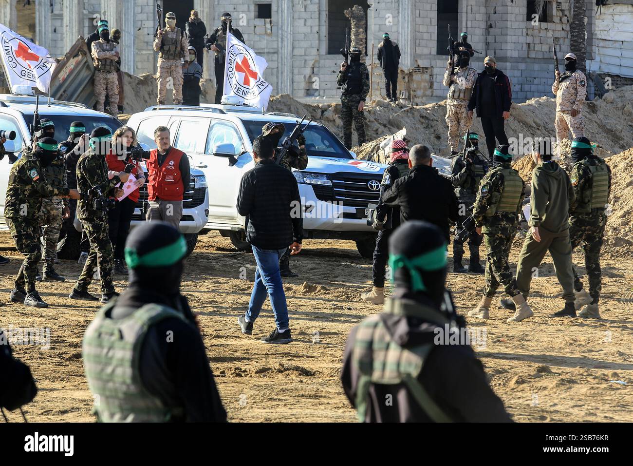Palestinian militant group Hamas fighters secure an area before handing ...