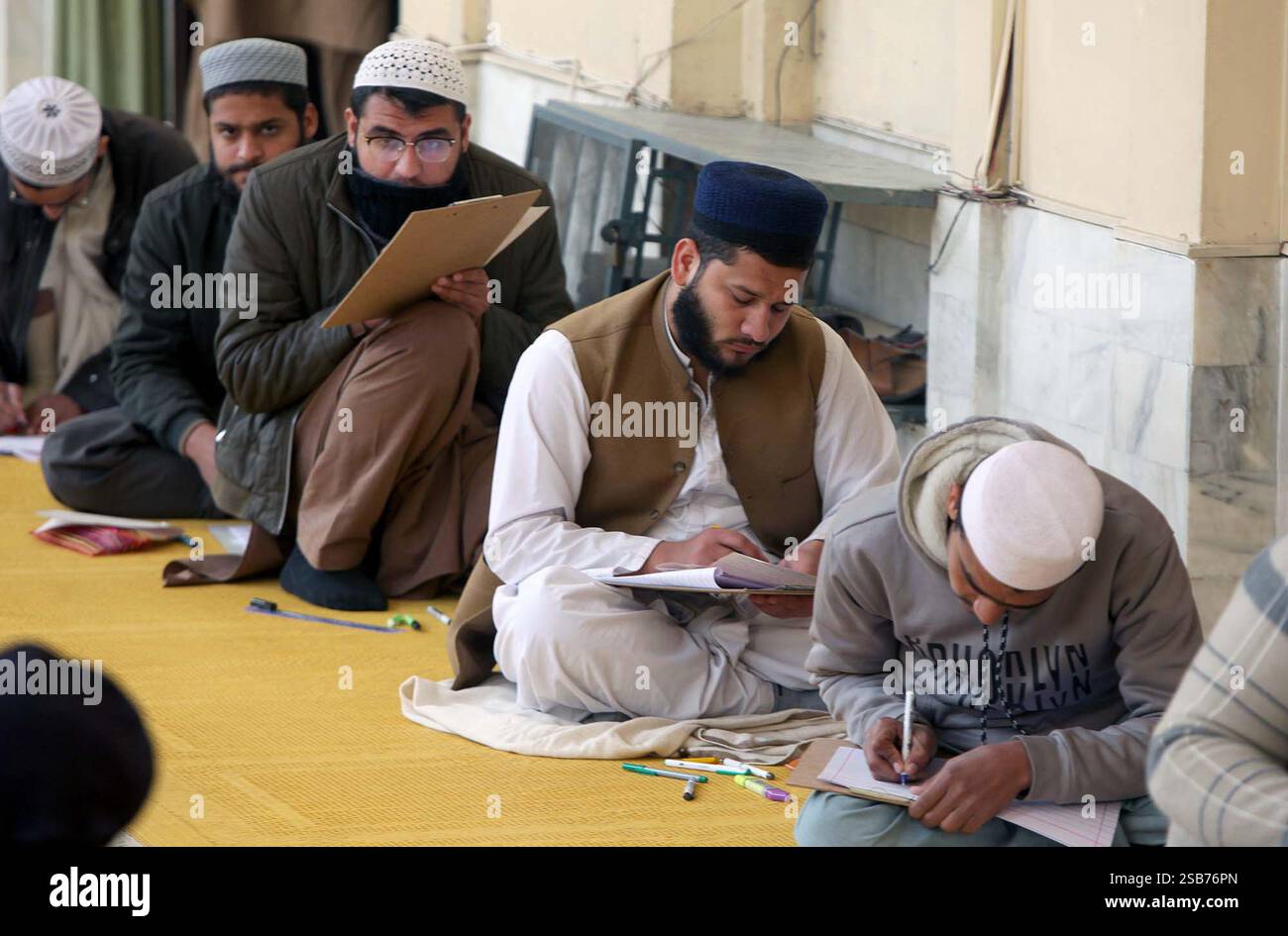 Students of Islamic seminary solve papers during Annual Examination of ...