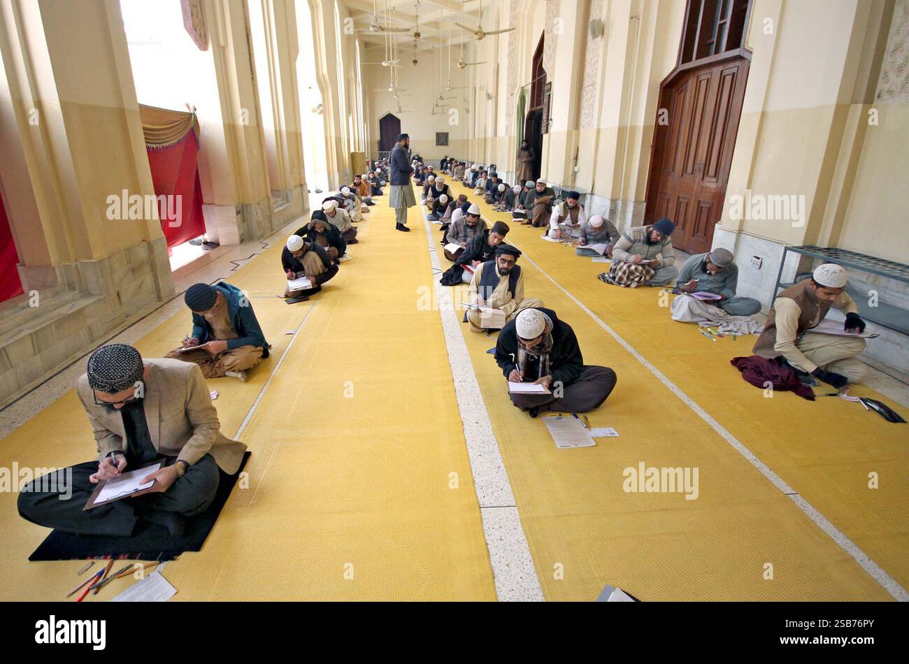 Students of Islamic seminary solve papers during Annual Examination of ...