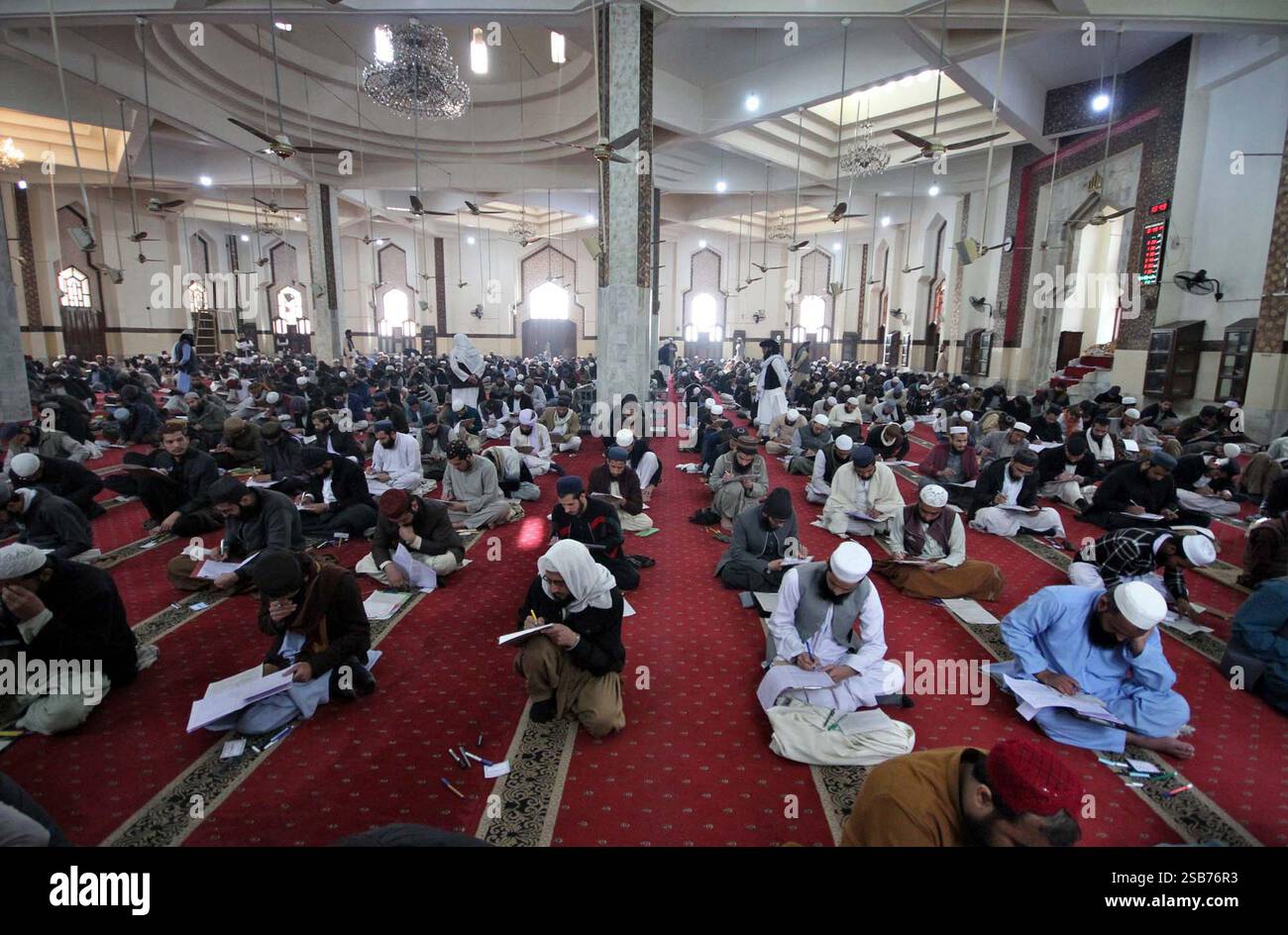 Students of Islamic seminary solve papers during Annual Examination of ...