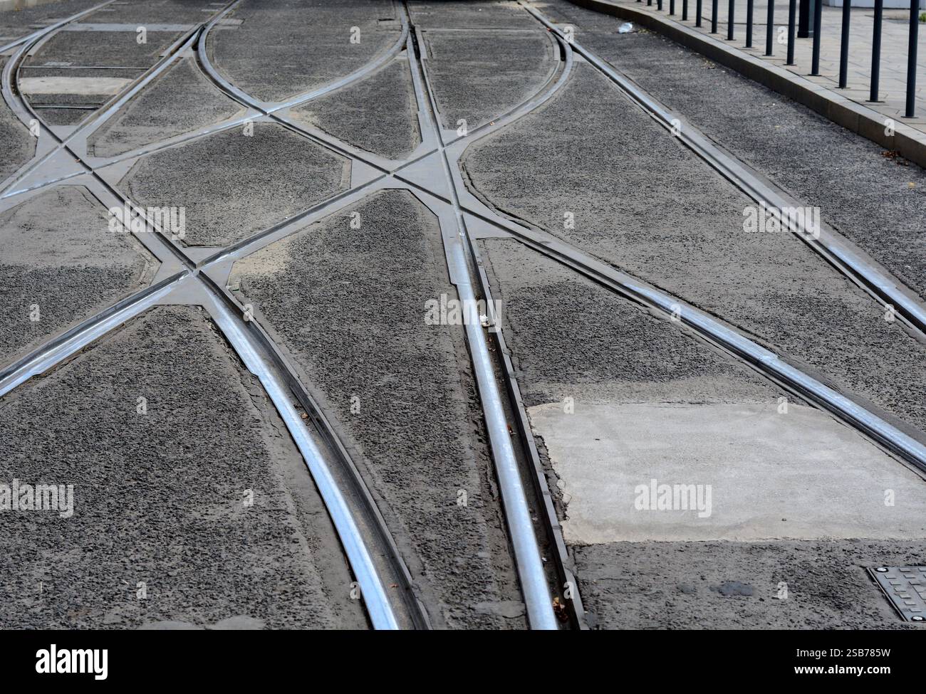 Tram tracks crossing each other on a busy Budapest street, capturing ...