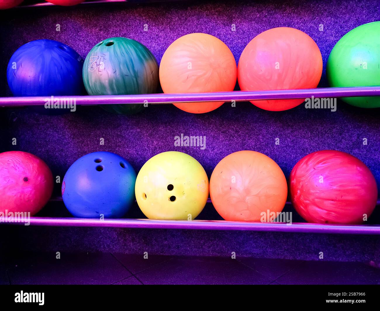 Rack of colorful bowling balls waiting to be chosen for a fun game ...