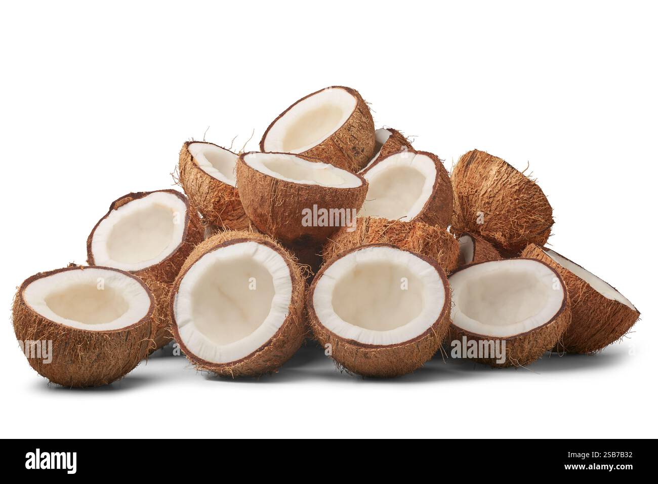 pile of coconuts cut in half isolated white background, brown fibrous ...