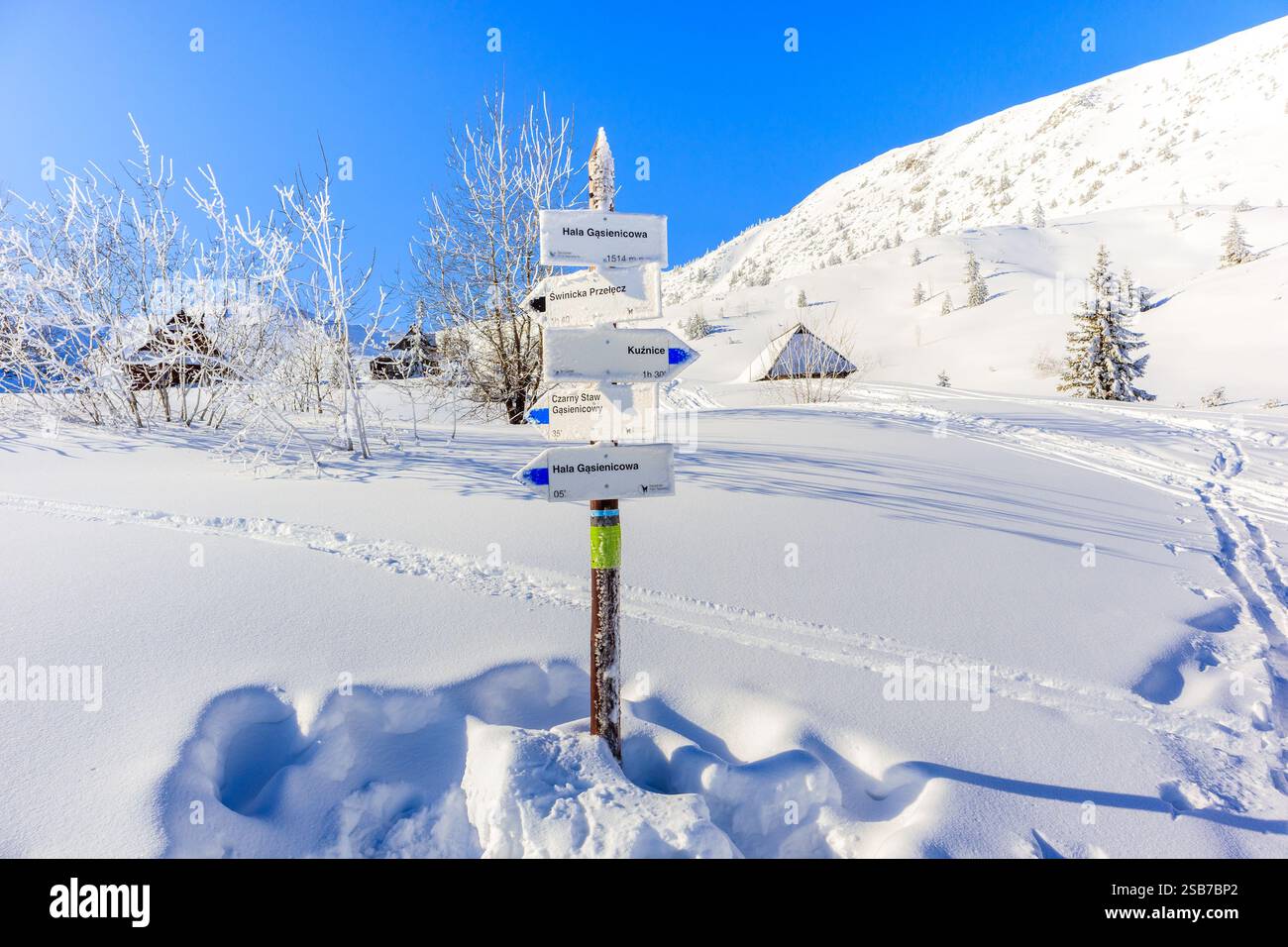 Signpost with walking and ski trails directions and times to reach ...