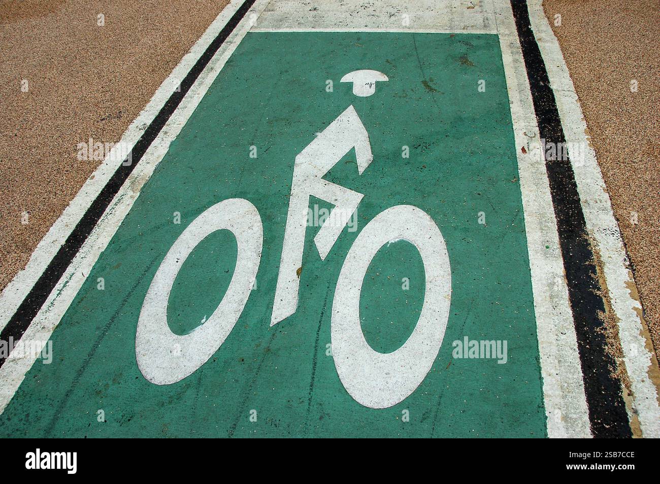 Urban road with a designated bike lane marked by a white bicycle symbol ...
