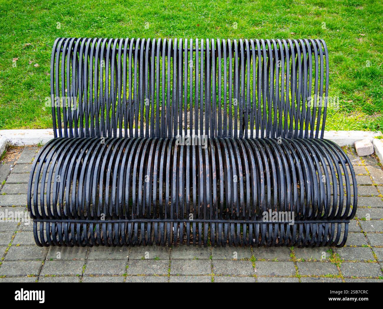 Figured bench made of bent thin profile pipe Stock Photo - Alamy