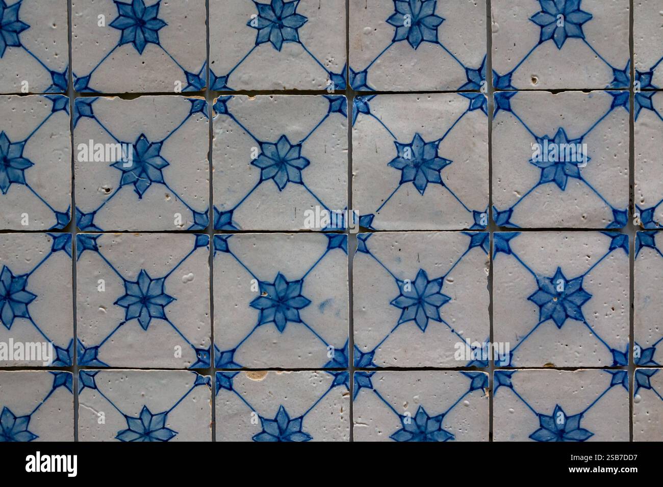 Traditional ceramic tiles on the wall, with geometrical floral motive ...