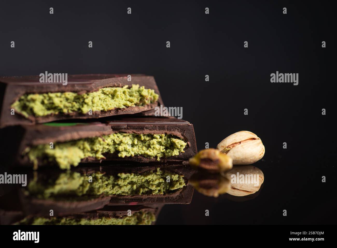 An enticing close-up of dark chocolate with a vibrant green pistachio ...