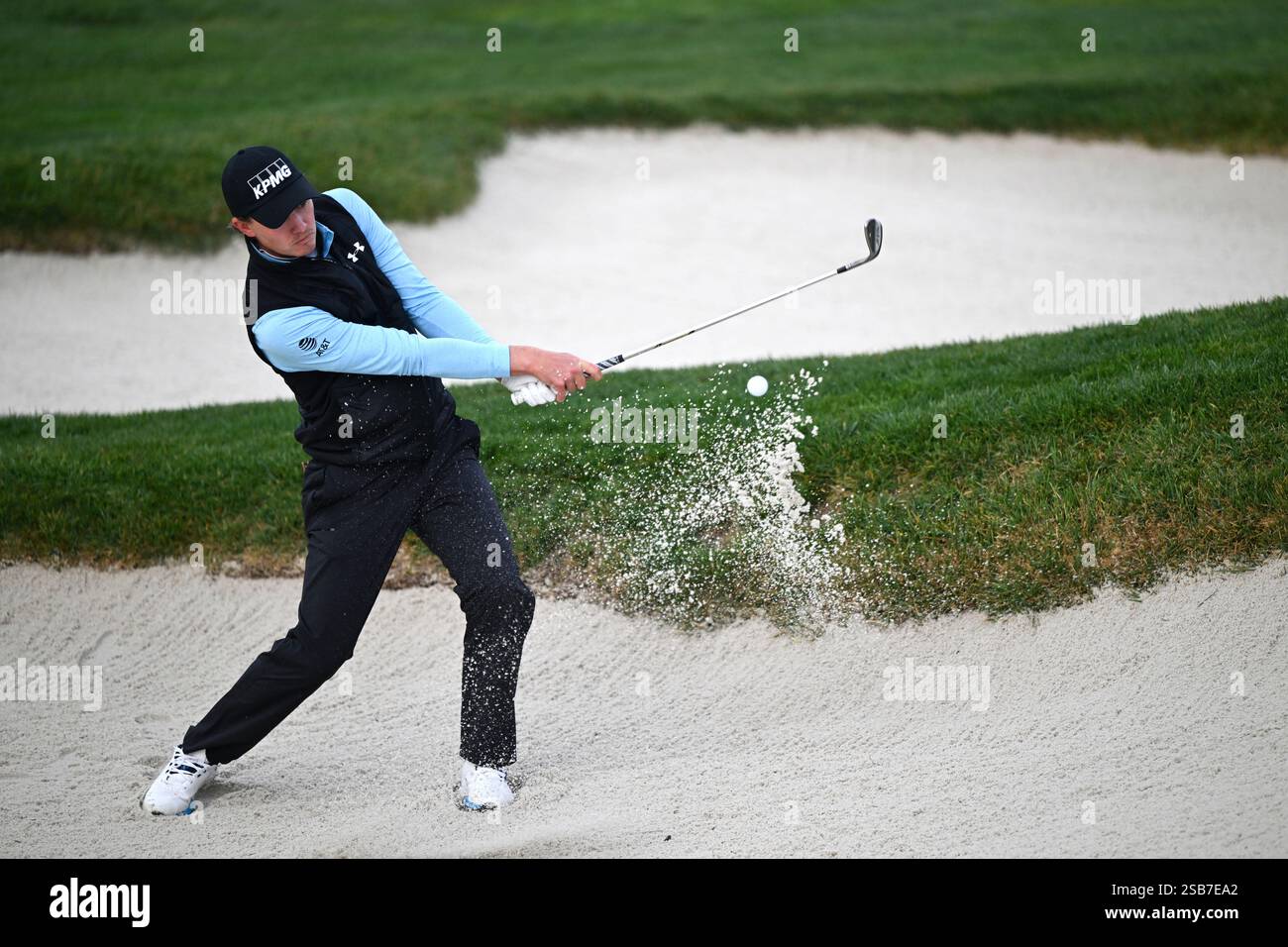 Maverick McNealy hits out of a sand trap on the first hole at Pebble ...