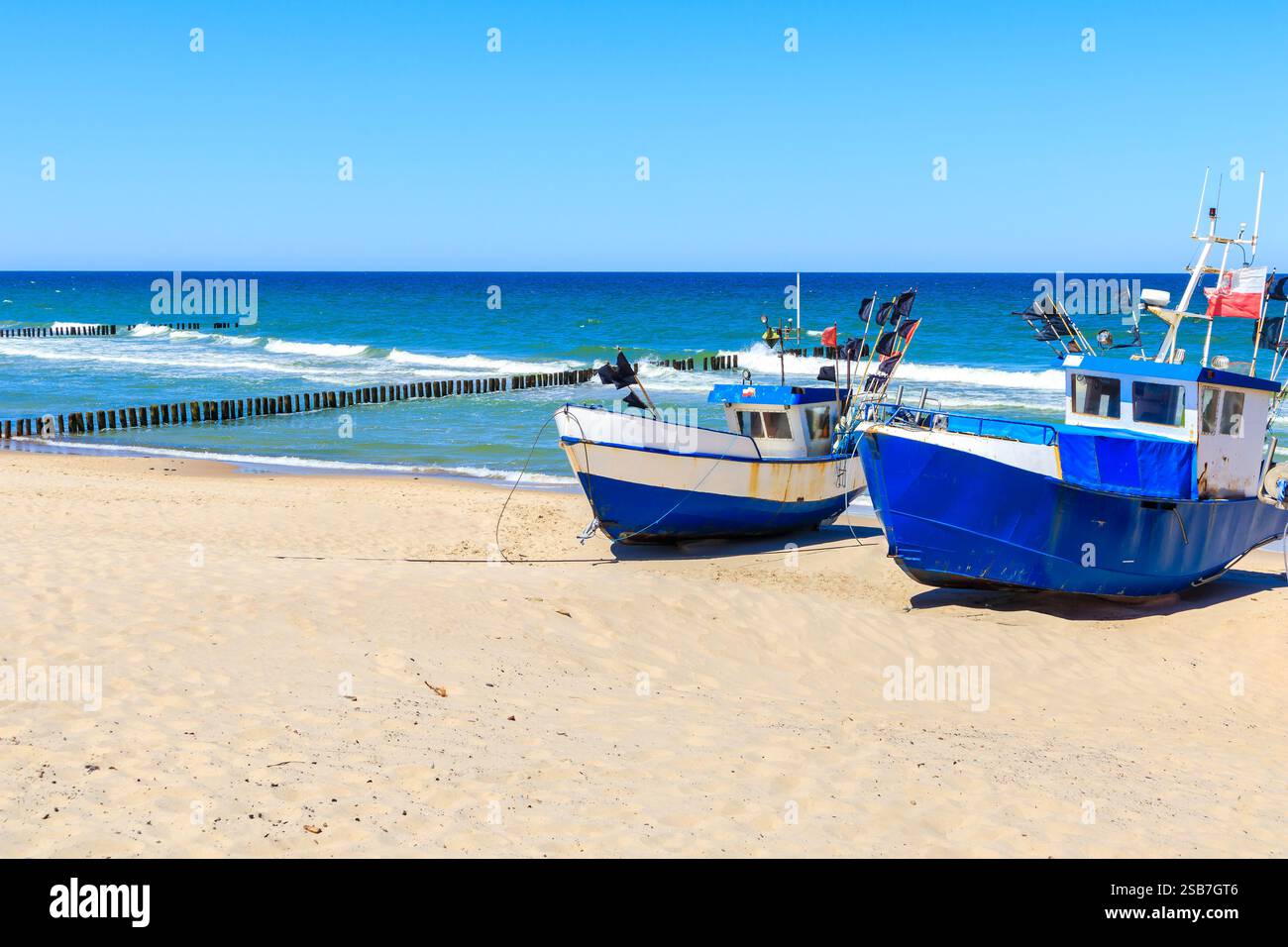 Fishing boats on sandy beach in Chlopy village port, Baltic Sea coast ...