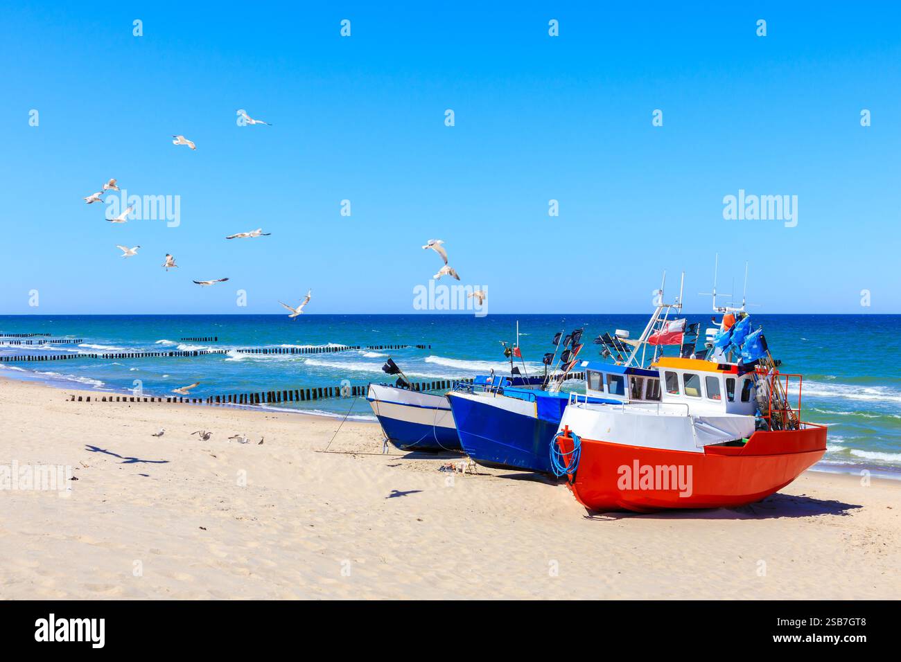 Fishing boats on sandy beach in Chlopy village port, Baltic Sea coast ...