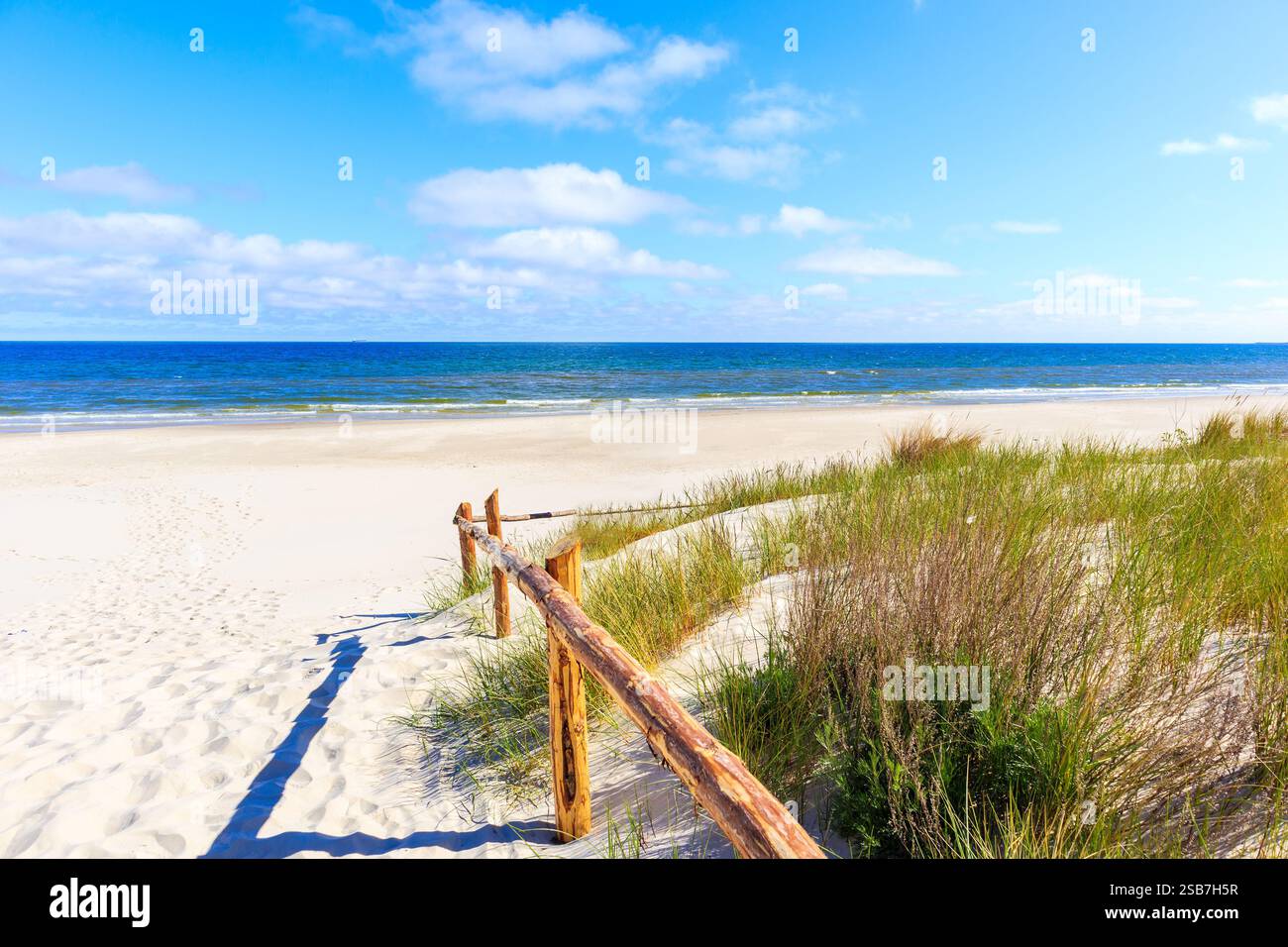 Entrance to beautiful white sand beach with dunes and blue sea near ...