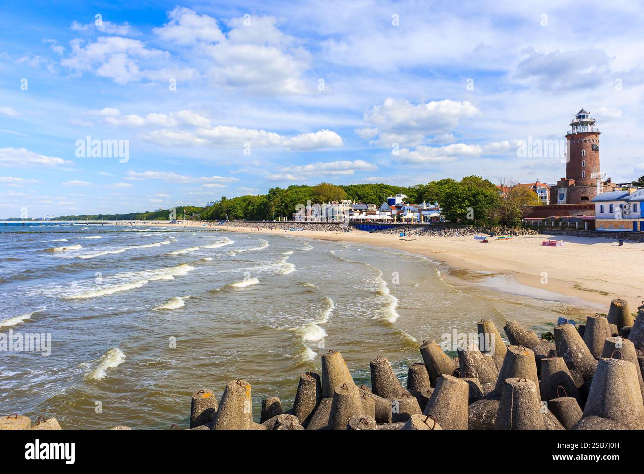 Lighthouse and beautiful white sand beach and blue sea in Kolobrzeg ...