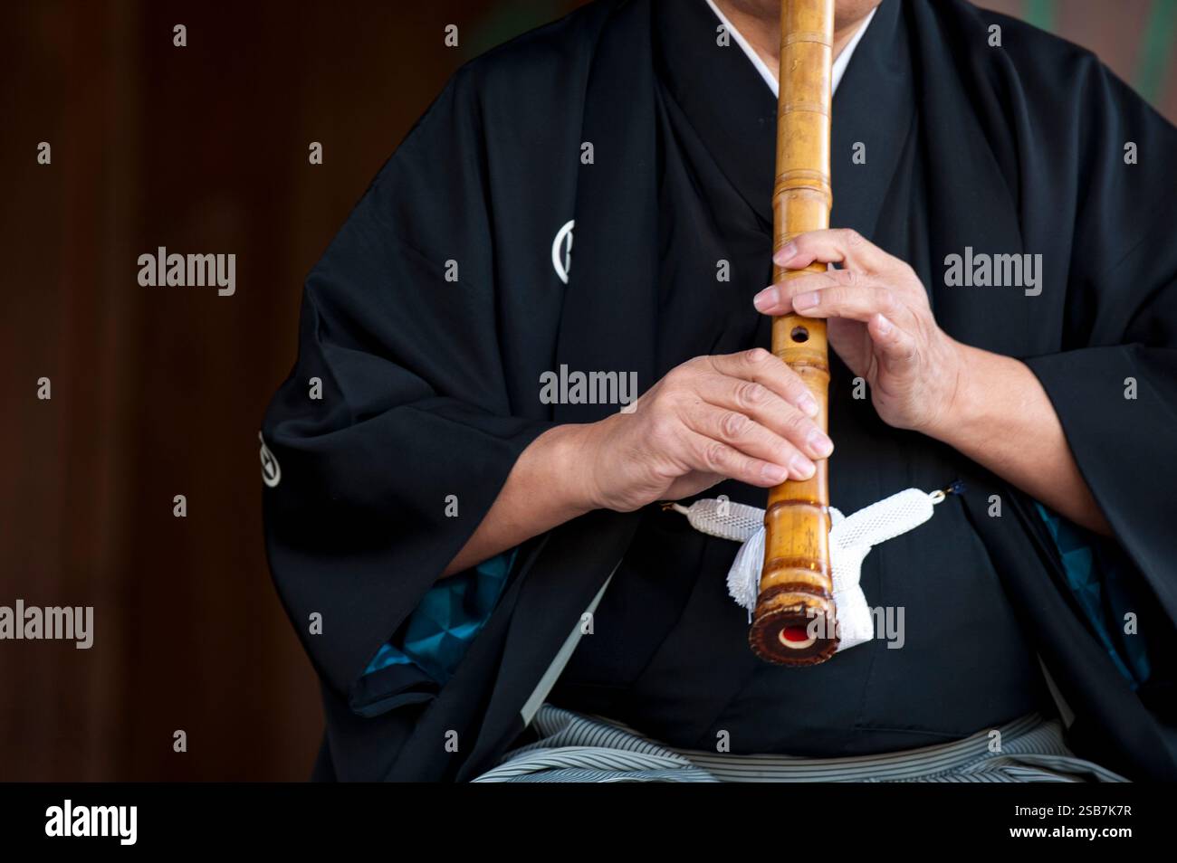 Man playing a shakuhachi: Japanese longitudinal, end-blown flute made ...