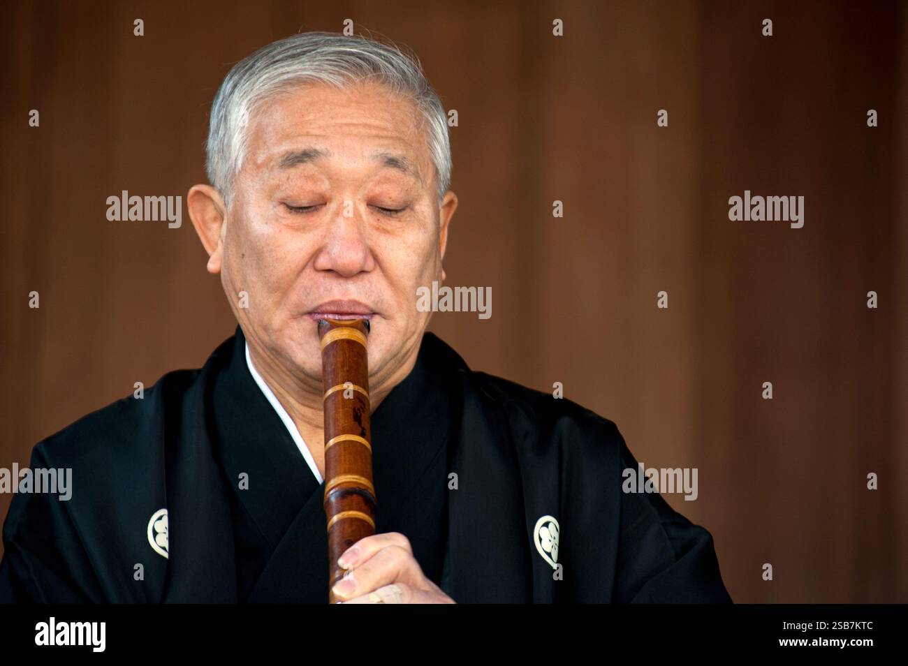 Man playing a shakuhachi: Japanese longitudinal, end-blown flute made ...