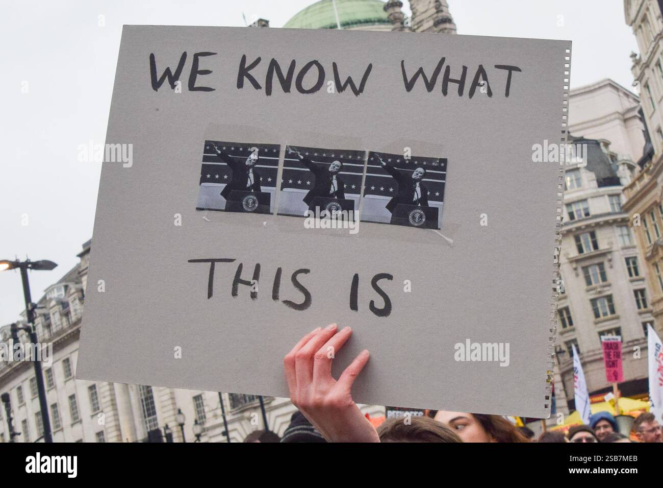 London, UK. 1st February 2025. A protester holds a sign with pictures ...