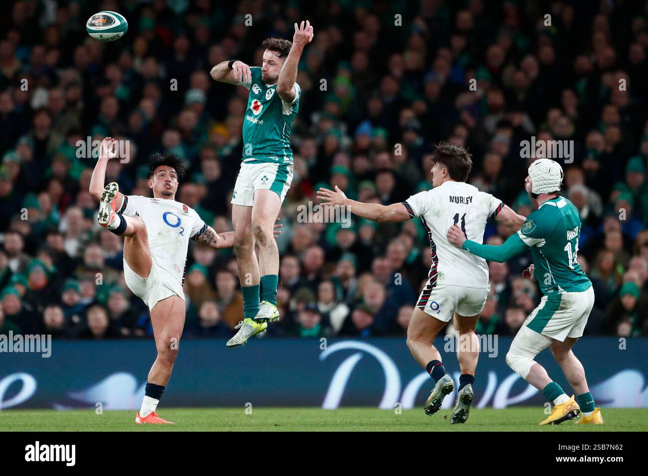 England's Marcus Smith, left, and Ireland's Hugo Keenan battle for the ...