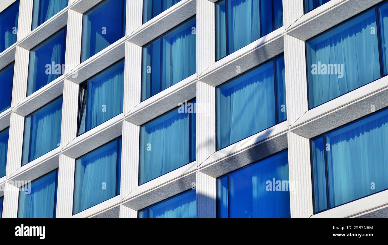 Large glass windows in a modern hotel building. Modern urban ...