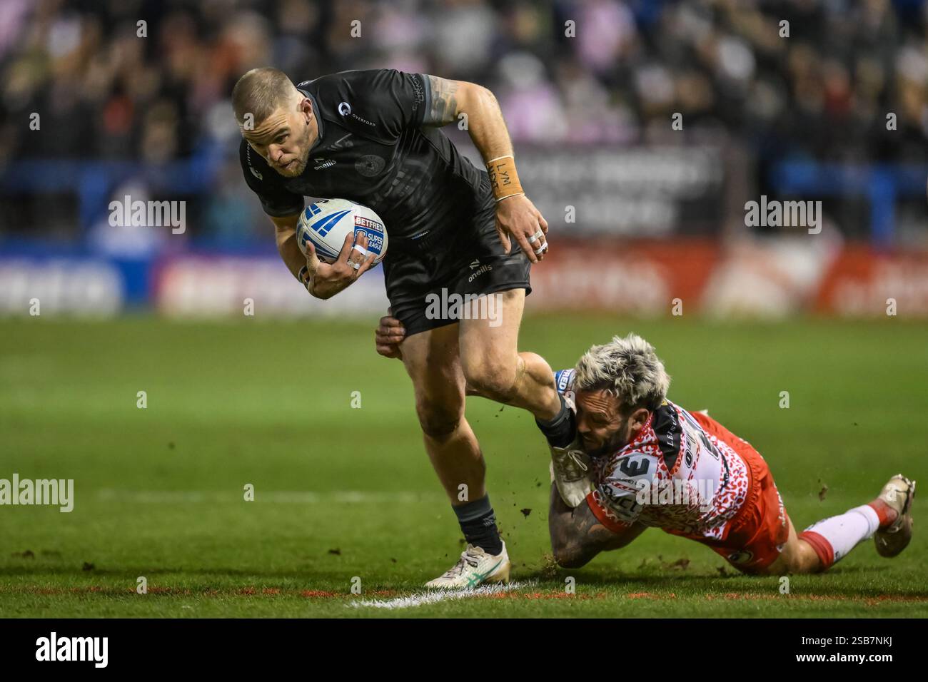 Matt Dufty of Warrington Wolves is tackled by Ethan O'neill of Leigh ...