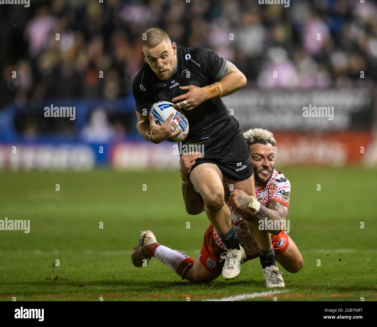 Matt Dufty of Warrington Wolves is tackled by Ethan O'neill of Leigh ...