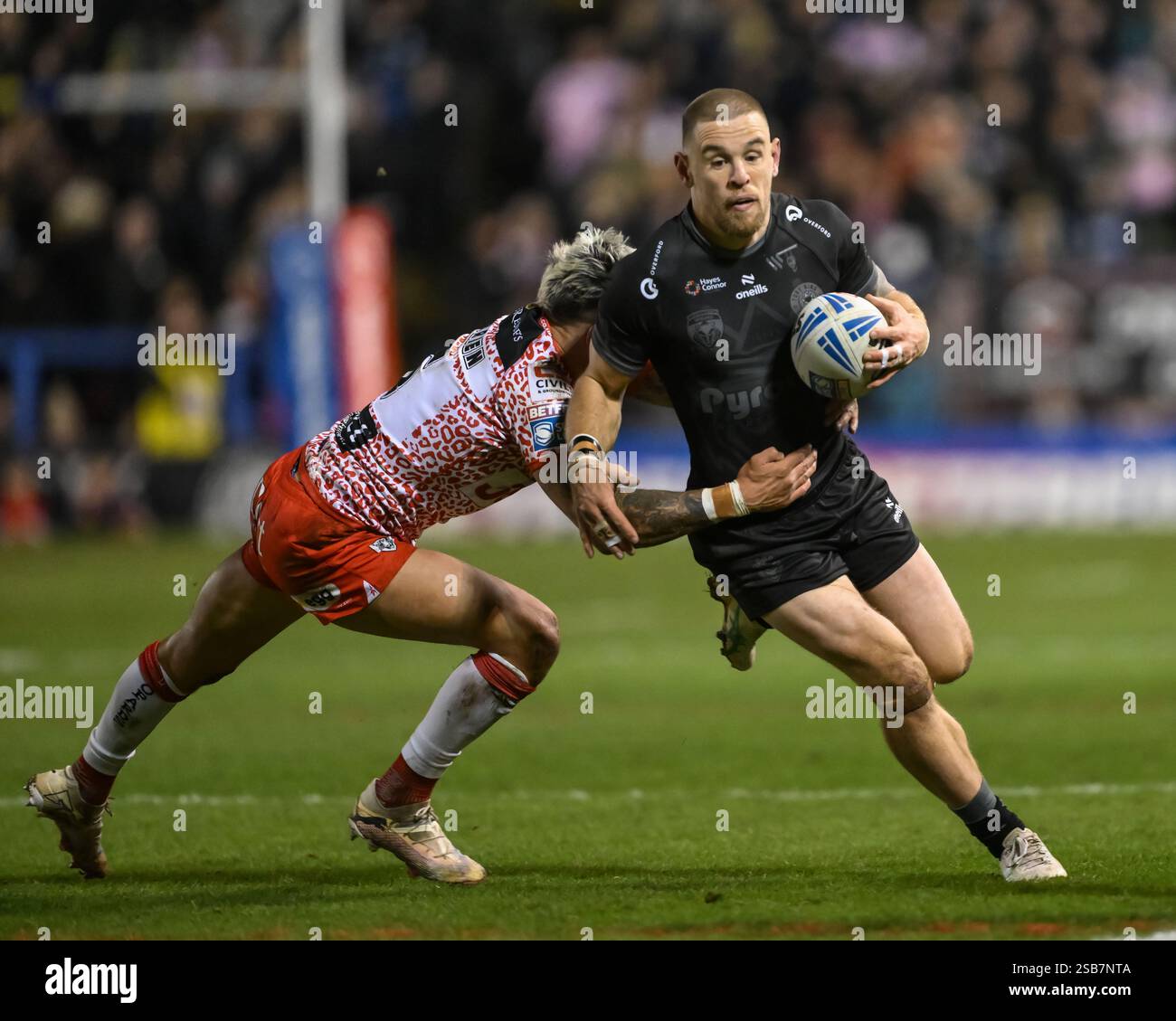 Matt Dufty of Warrington Wolves is tackled by Ethan O'neill of Leigh ...