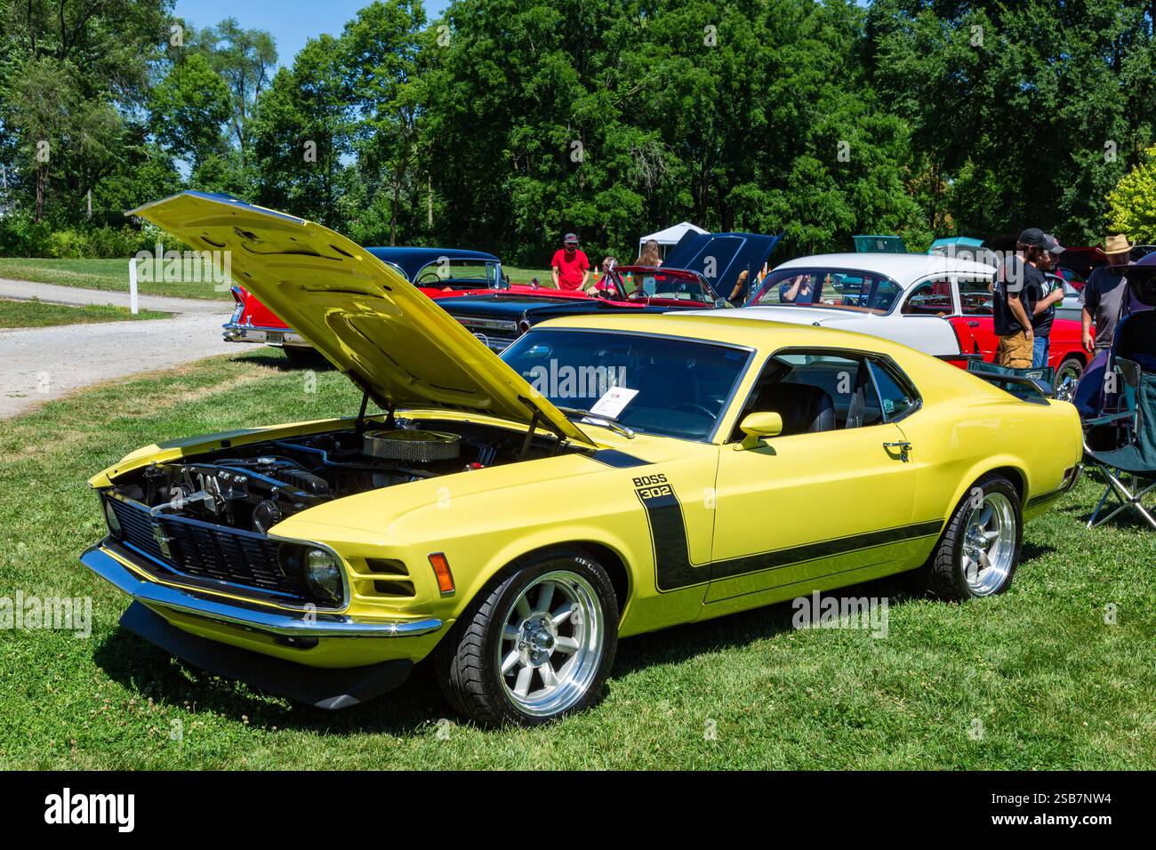 A yellow 1970 Ford Mustang Boss 302 fastback coupe on display at a car ...