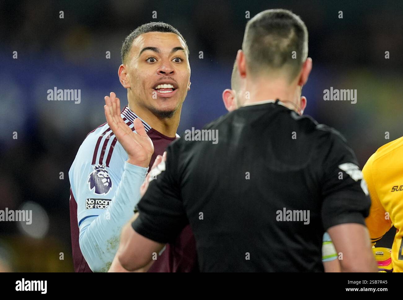 Aston Villa's Morgan Rogers (left) speaks with referee Andrew Madley ...