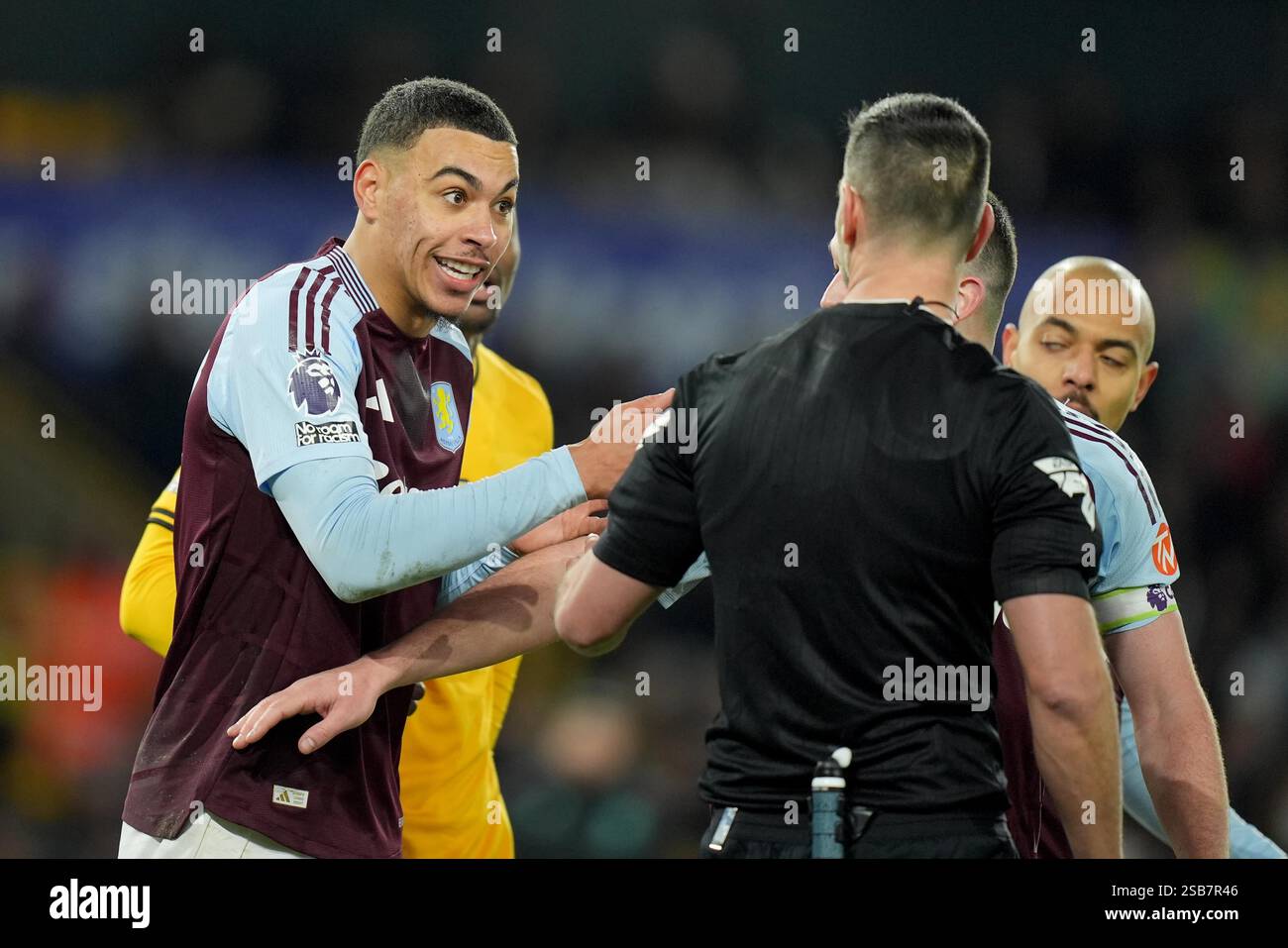 Aston Villa's Morgan Rogers (left) speaks with referee Andrew Madley ...