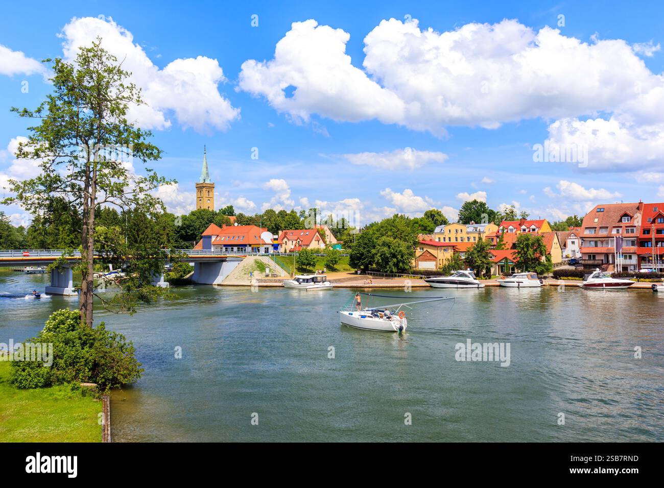 Yacht sailing on canal in Mikolajki town on sunny summer day, Mazury ...
