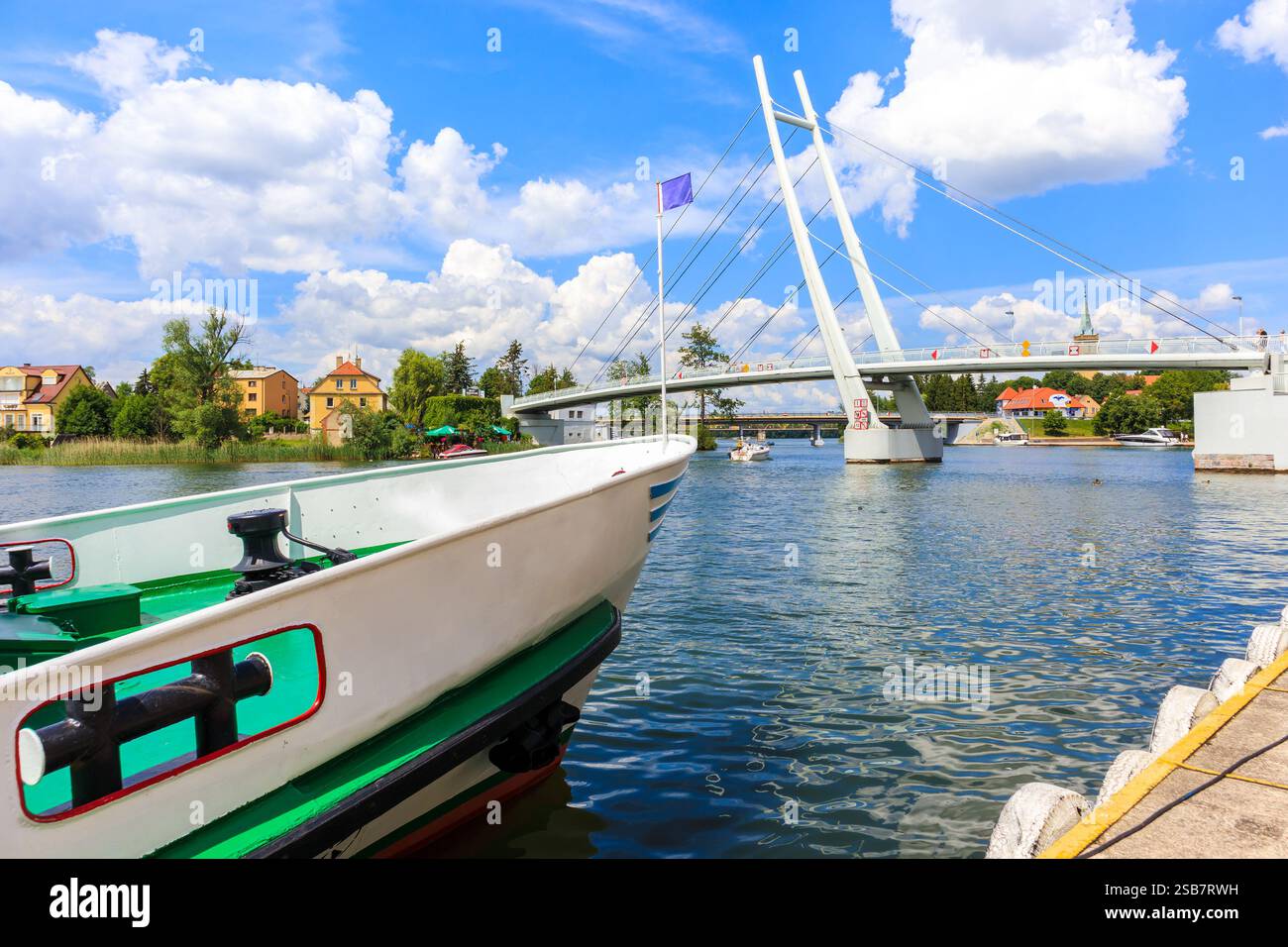 Boat mooring in Mikolajki port with bridge in background on sunny ...
