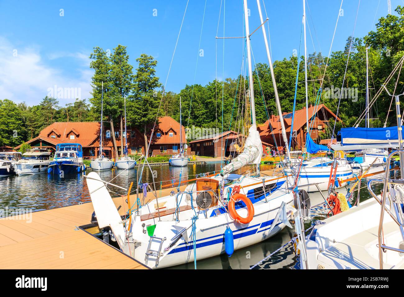 Sailing boats on lake shore in Ruciane-Nida "Pod Debem" town marina in ...
