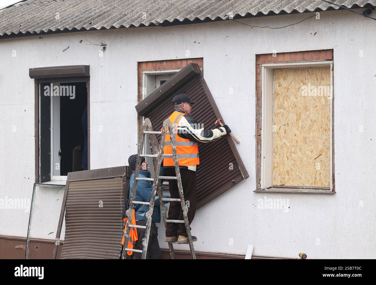 KHARKIV, UKRAINE - FEBRUARY 1, 2025 - Municipal workers replace broken ...