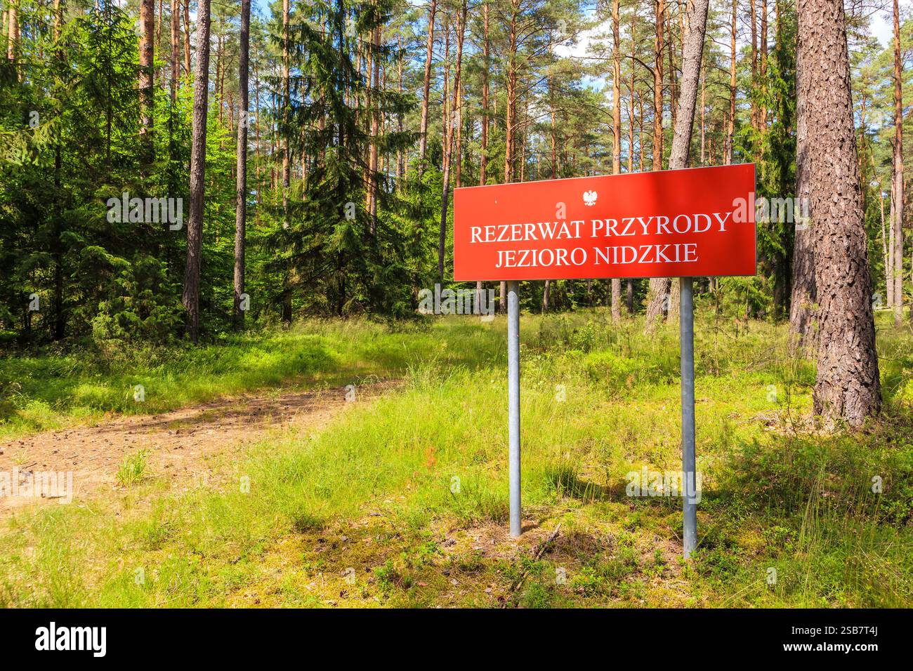 Red sign "Rezerwart Przyrody Jezioro Nidzkie" which translation is ...