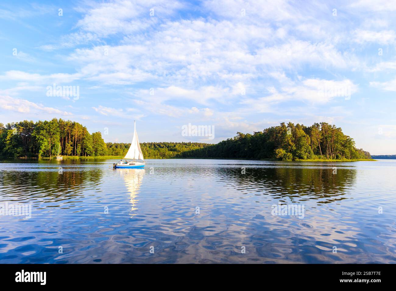 Sailing boat on lake Nidzkie in Ruciane-Nida at sunset time, Mazury ...
