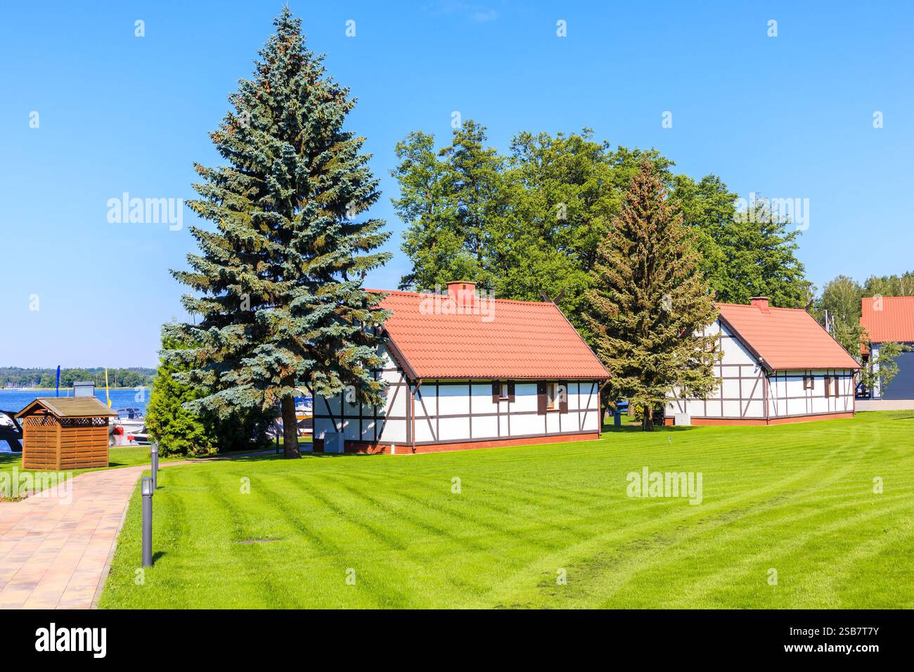 Traditional style rustic houses in Piaski port near lake Beldany ...