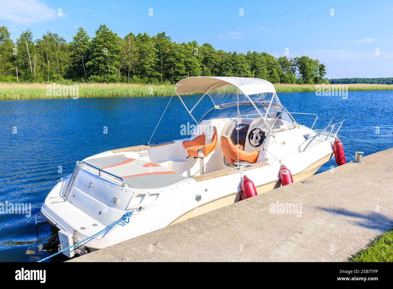 Luxury motorboat anchoring in Pisz sailing port on Lake Ros on summer ...