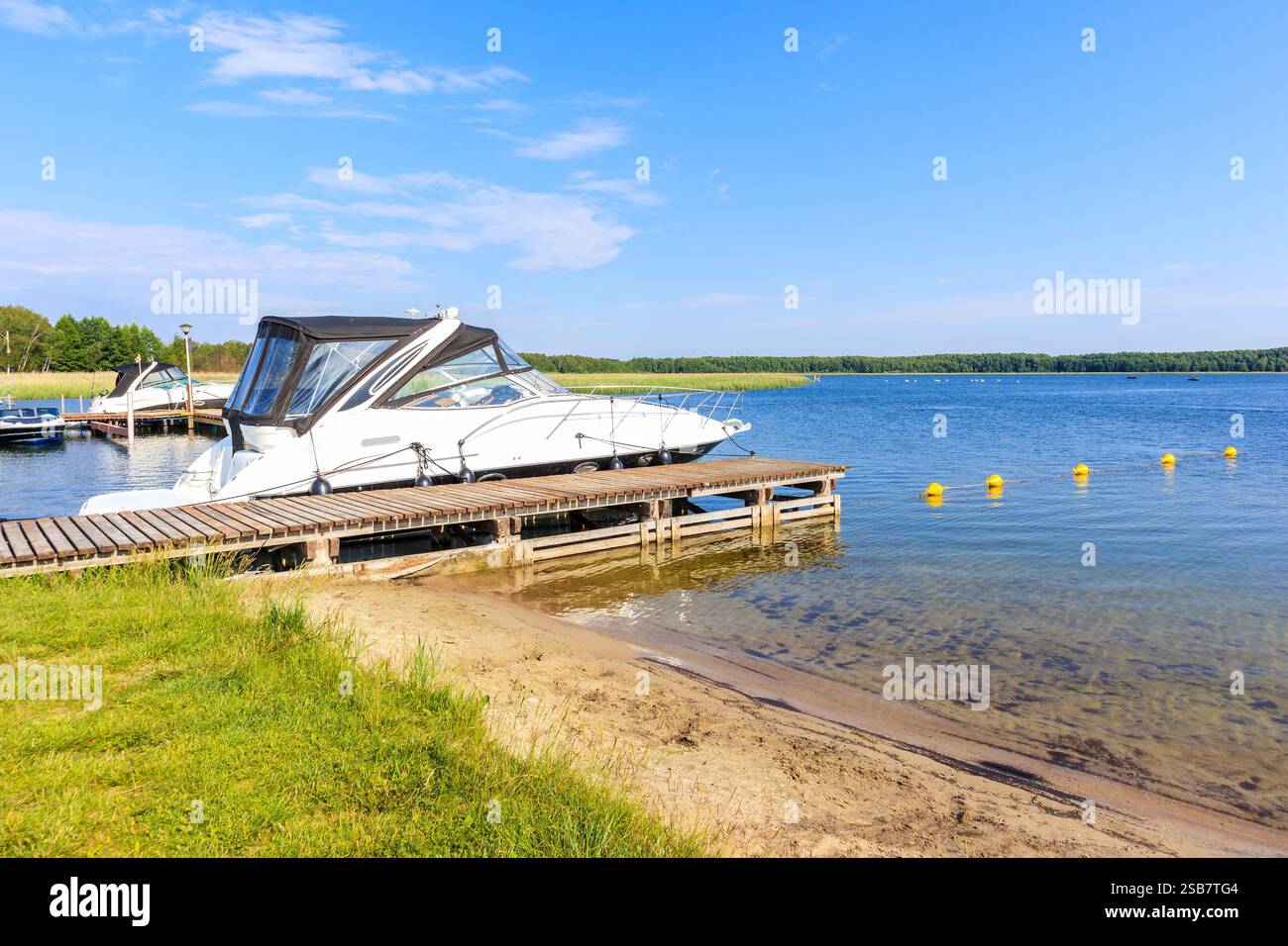 Boats anchoring at beach in Pisz sailing port on Lake Ros on summer ...