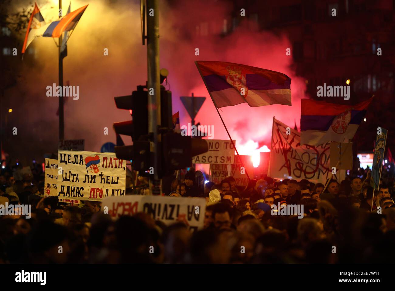 People wave flags and light up flares during a protest over the ...