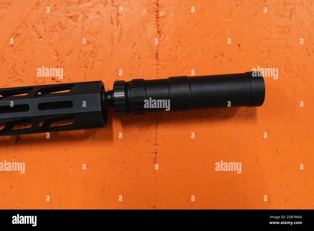 A silencer mounted on a modern rifle, close-up photo at a shooting ...