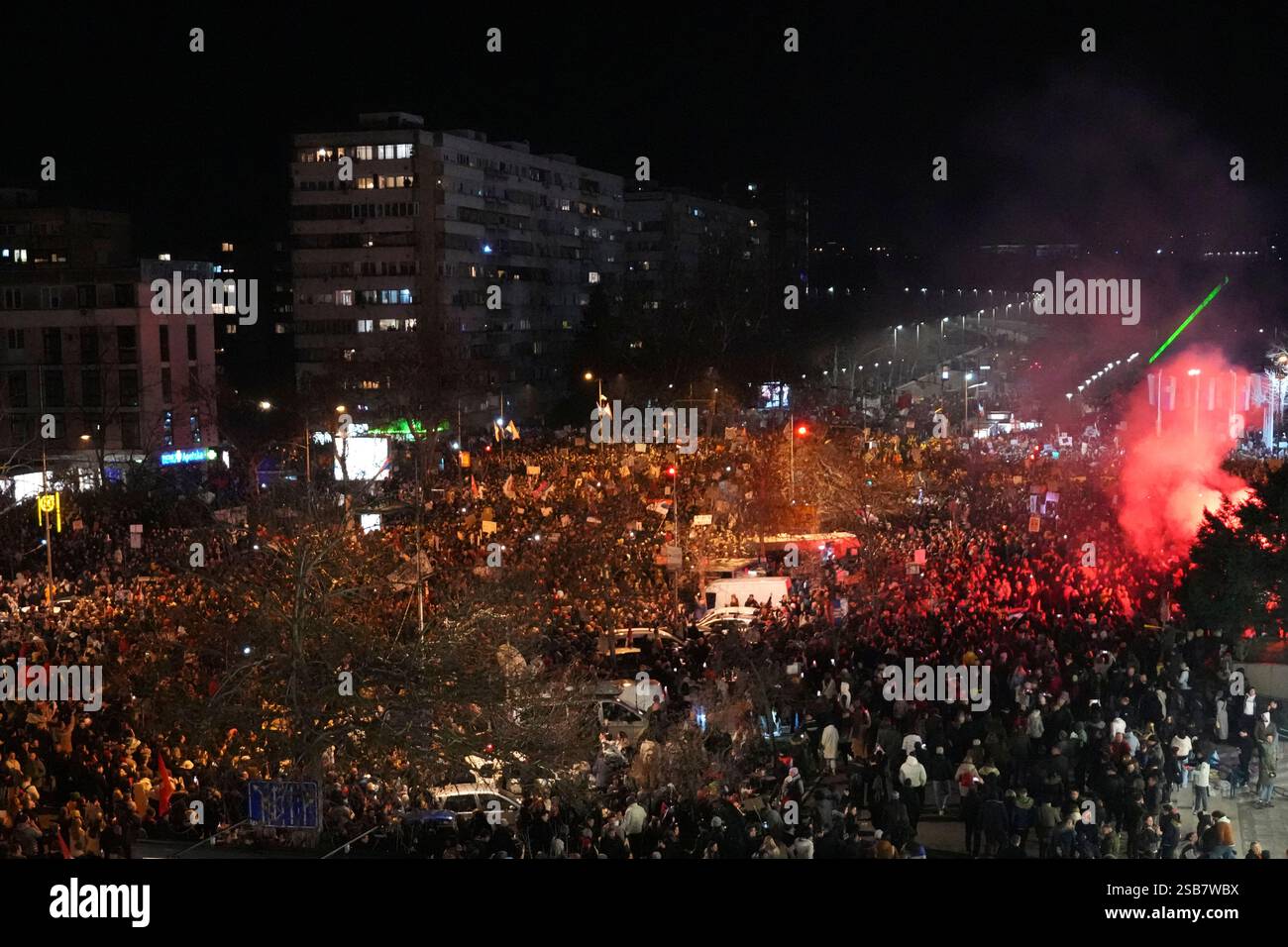 People light up flares as they gather for a protest over the collapse ...