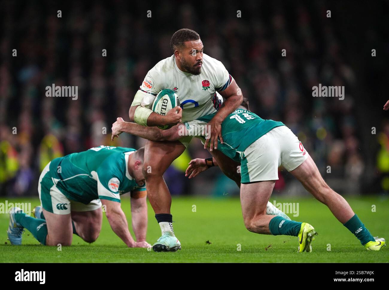 England's Ollie Lawrence tackled by Ireland's Cian Healy (left) and ...