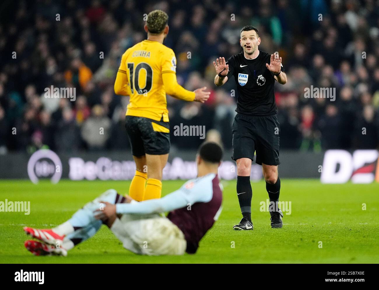 Referee Andrew Madley (right) gestures towards Wolverhampton Wanderers ...