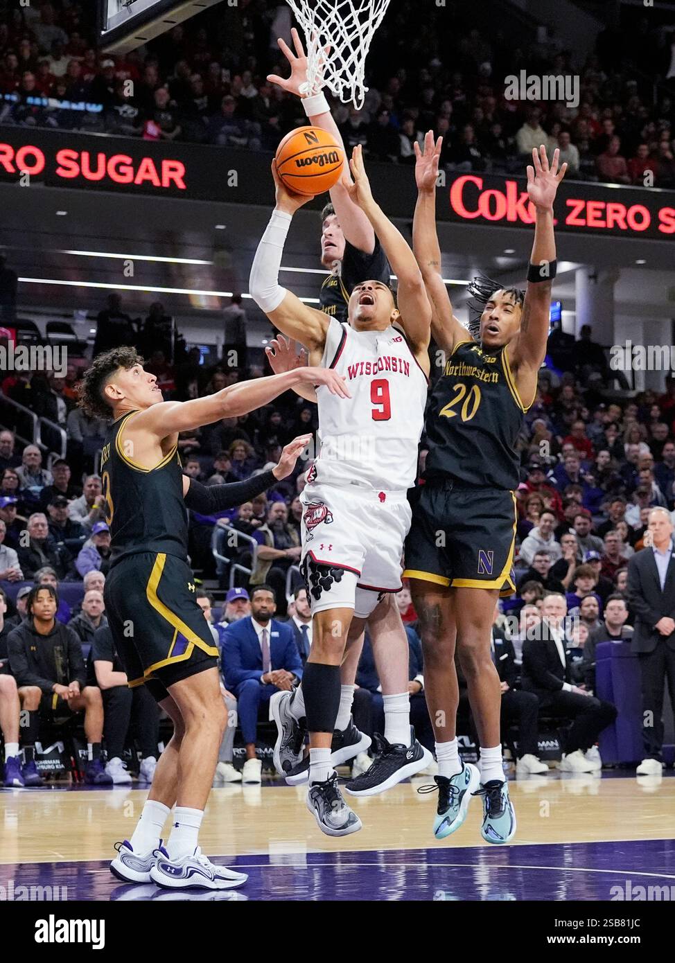 Wisconsin guard John Tonje (9) drives to the basket against ...
