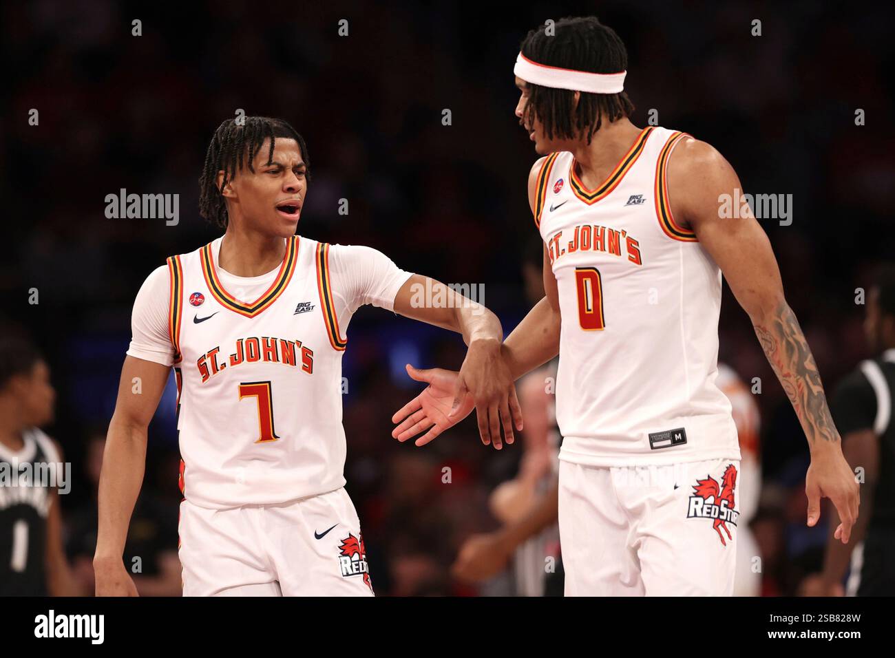 St. John's guard Simeon Wilcher (7) high fives St. John's guard Aaron ...