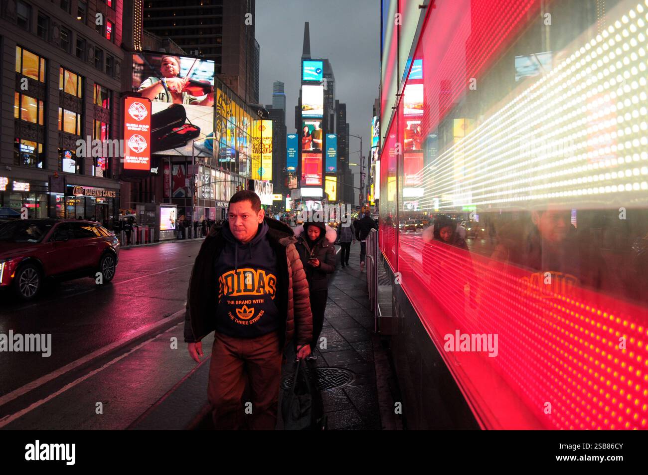People walk past a lighting installation of the American flag in Times ...