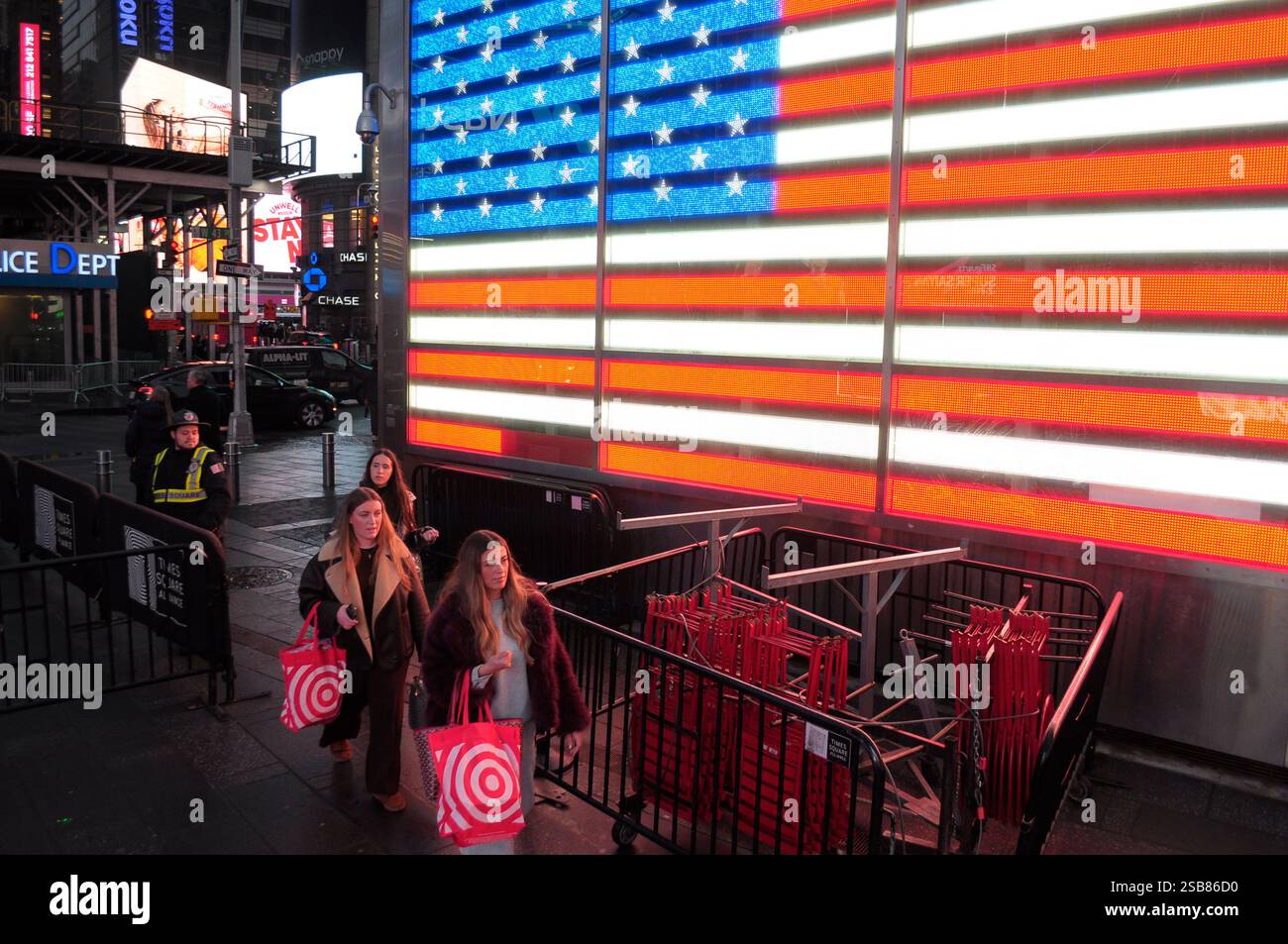 People walk past a lighting installation of the American flag in Times ...