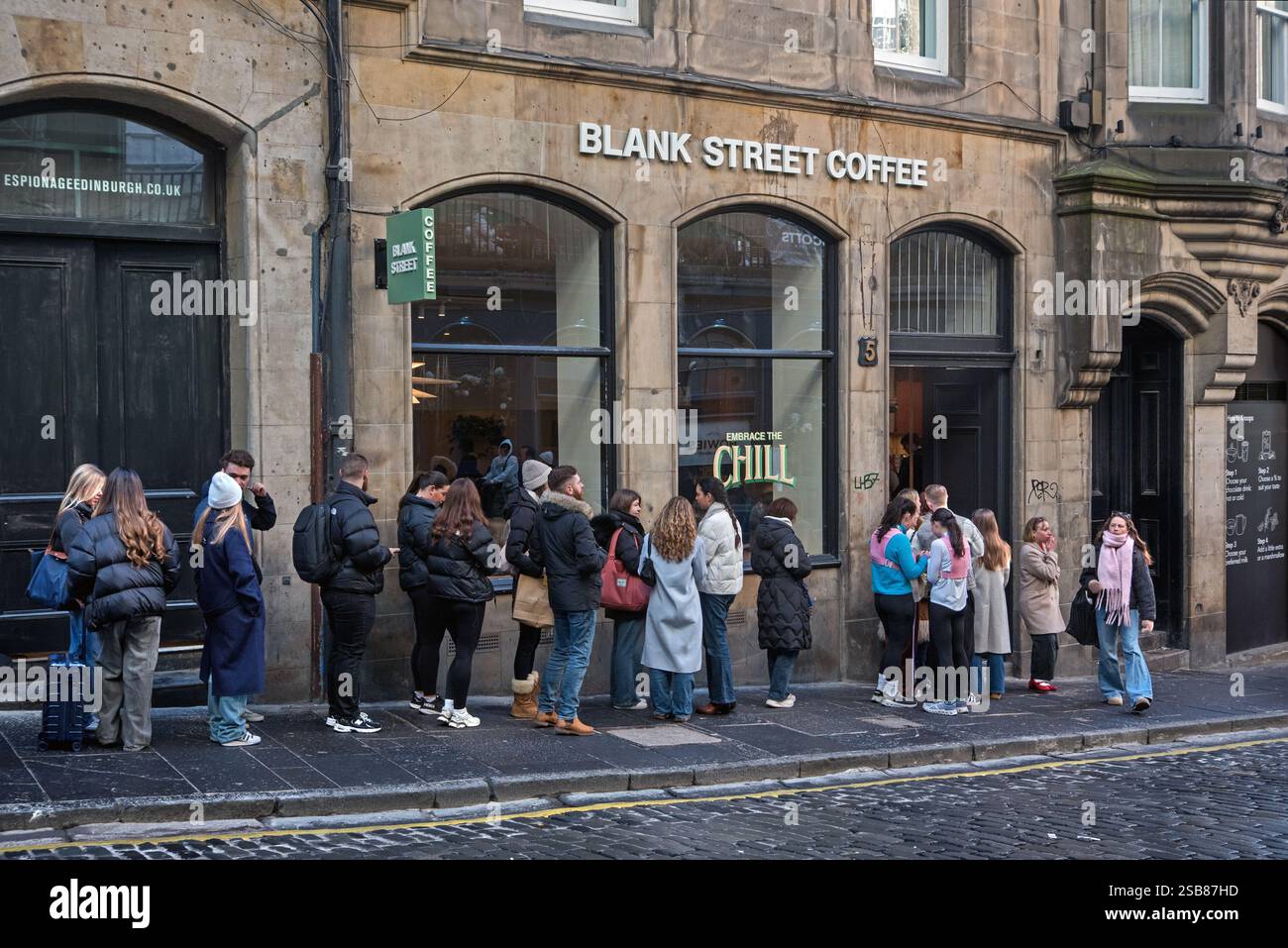 Young people queueing outside Blank Street Coffee on Victoria Street in Edinburgh's Old Town ...