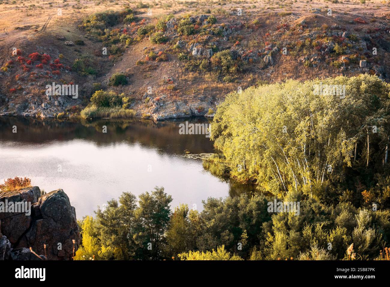 a huge wide river flows among steep banks Stock Photo - Alamy