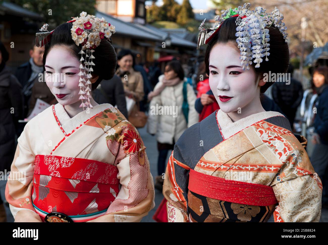 Two female tourists dressed up like maiko (apprentice geisha) walking ...